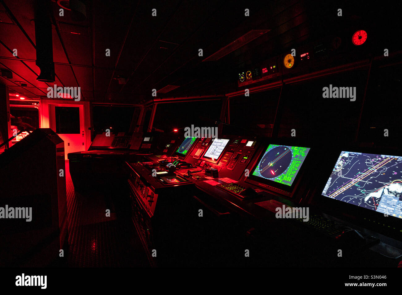 Bridge navigation console at night mode Stock Photo - Alamy