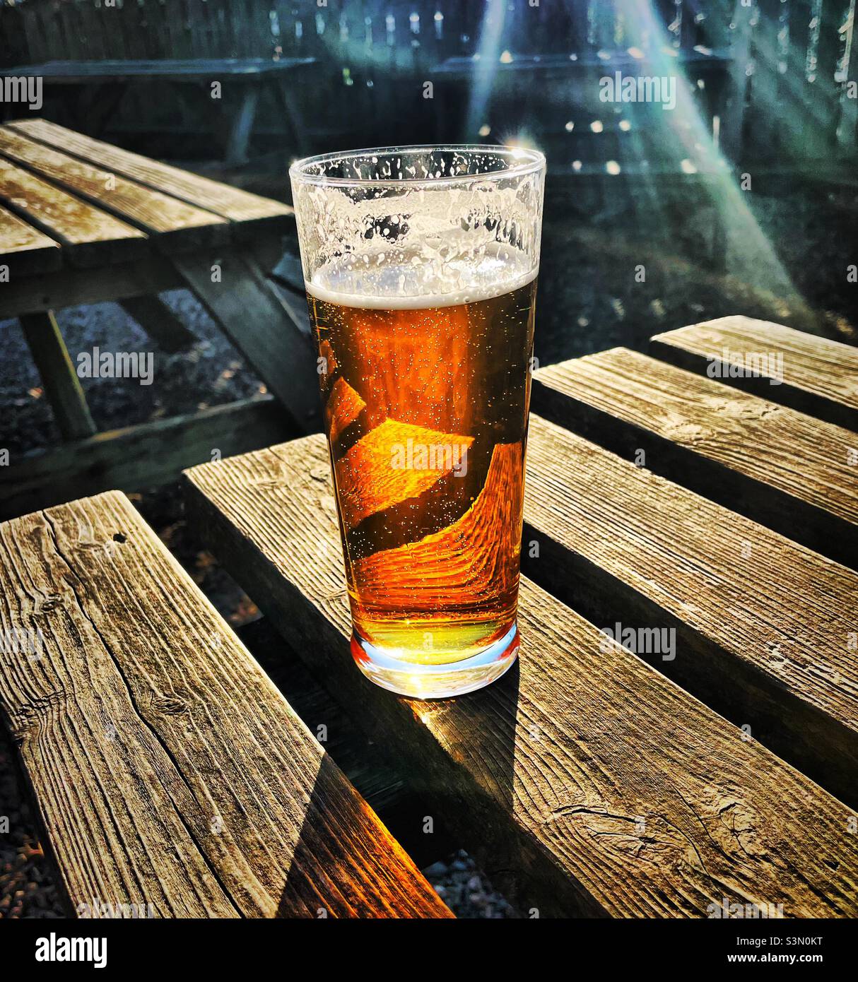 ‘Cold & Crisp’ a pint of lager on a beer garden table in the winter ...