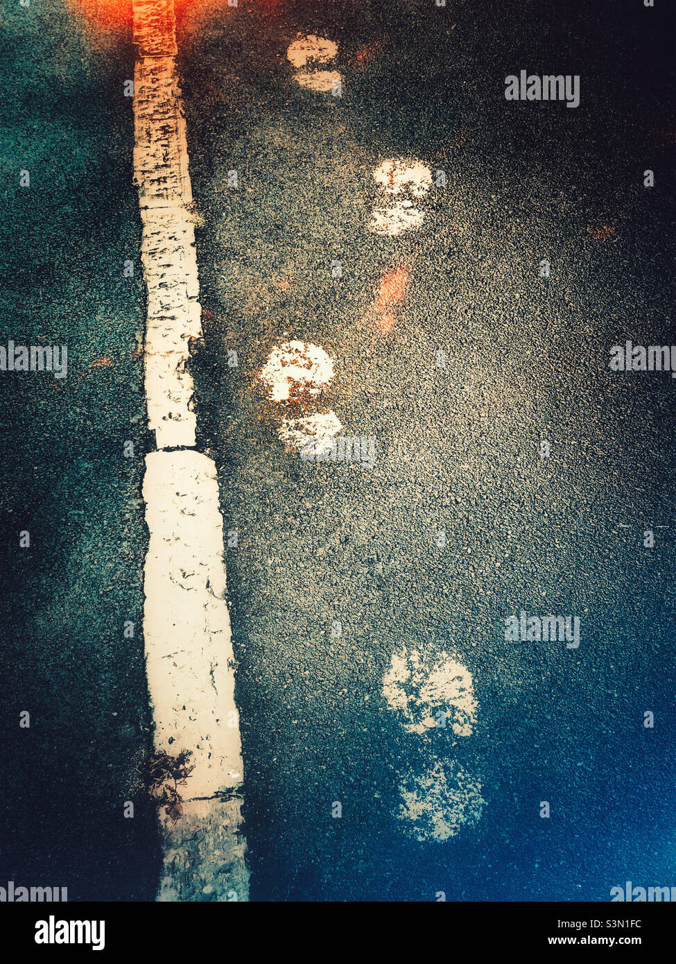 Painted footprints going off into the distance on a pavement Stock ...