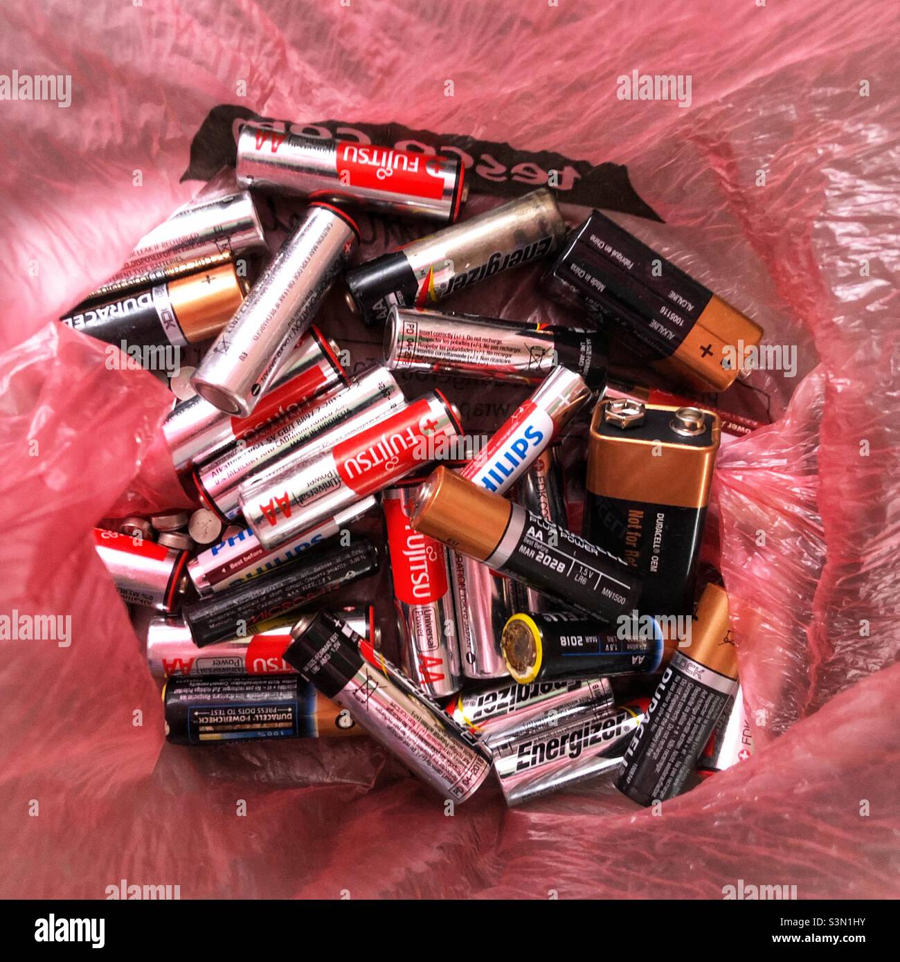 Battery recycling. Batteries collected in a plastic bag for kerbside ...