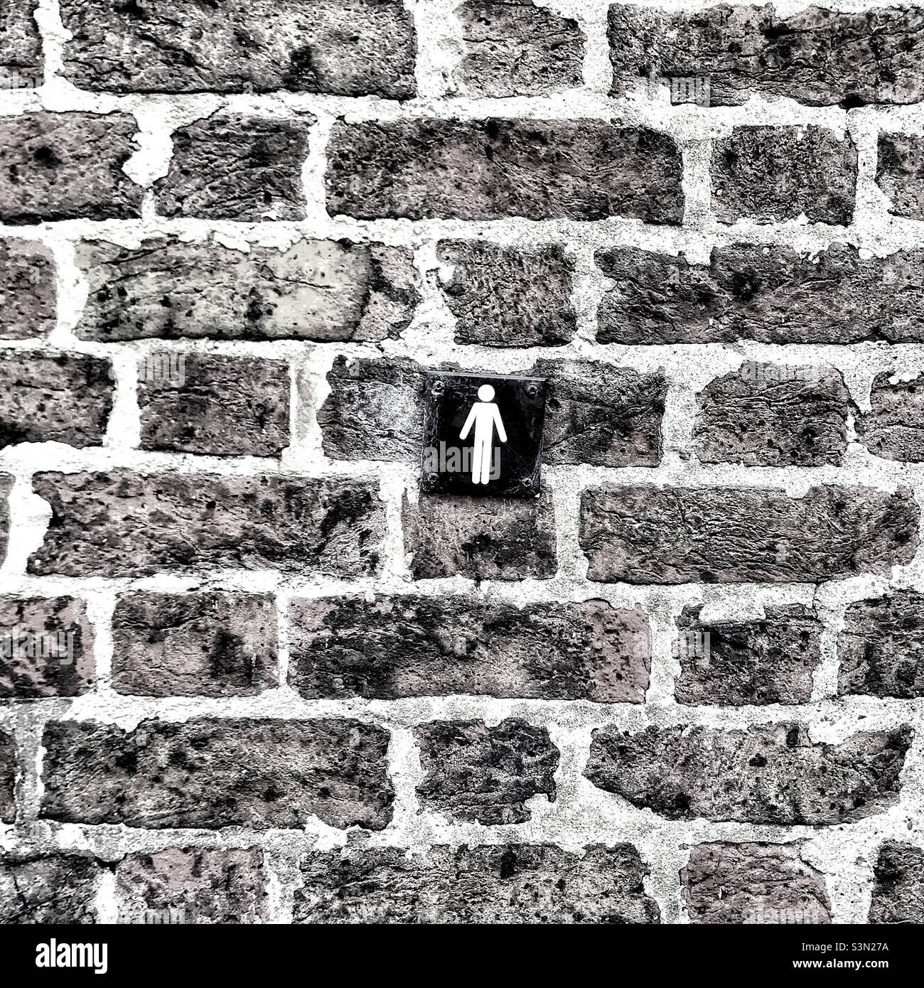 Big wall, little sign Stock Photo - Alamy