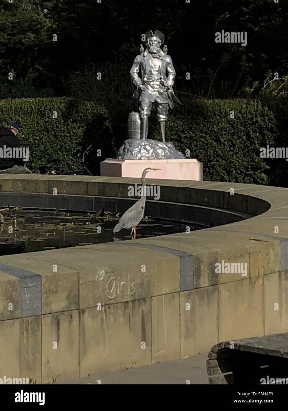 Heron with statue Stock Photo - Alamy