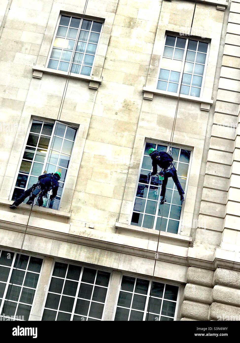SAS commandos? No, abseiling window cleaners working on a building in ...