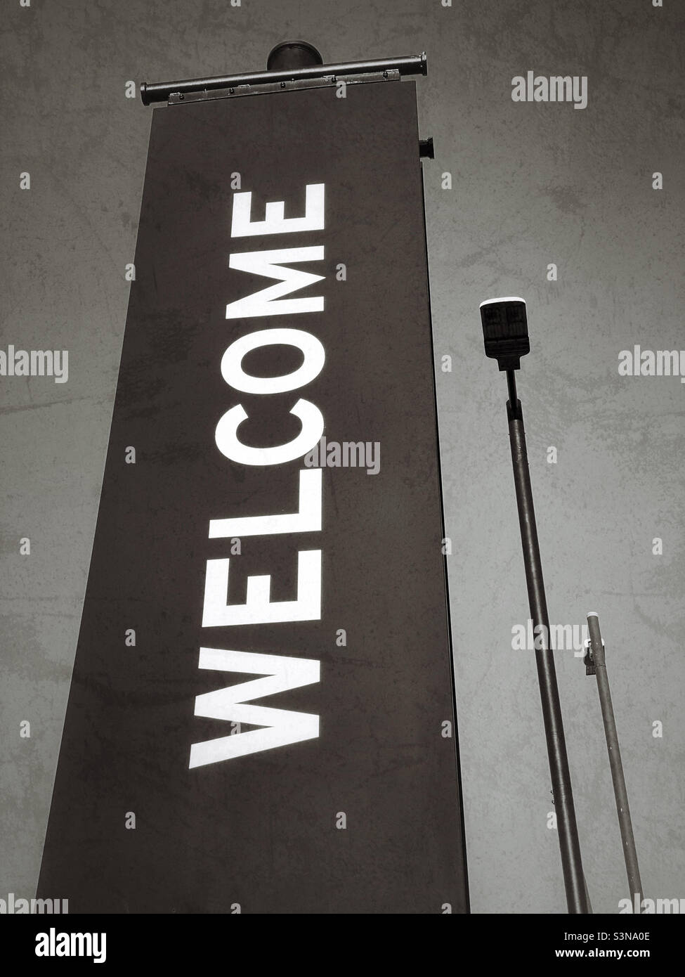 WELCOME. A large sign welcoming shoppers to a retail outlet. In fact ...