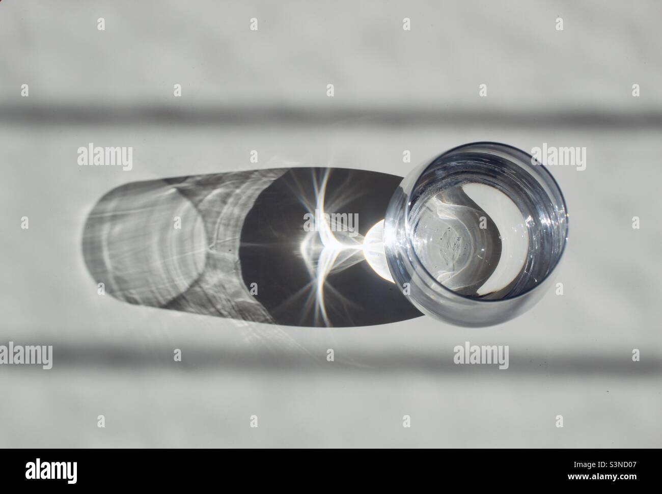 A glass of water. Shadows. Minimalism Stock Photo - Alamy