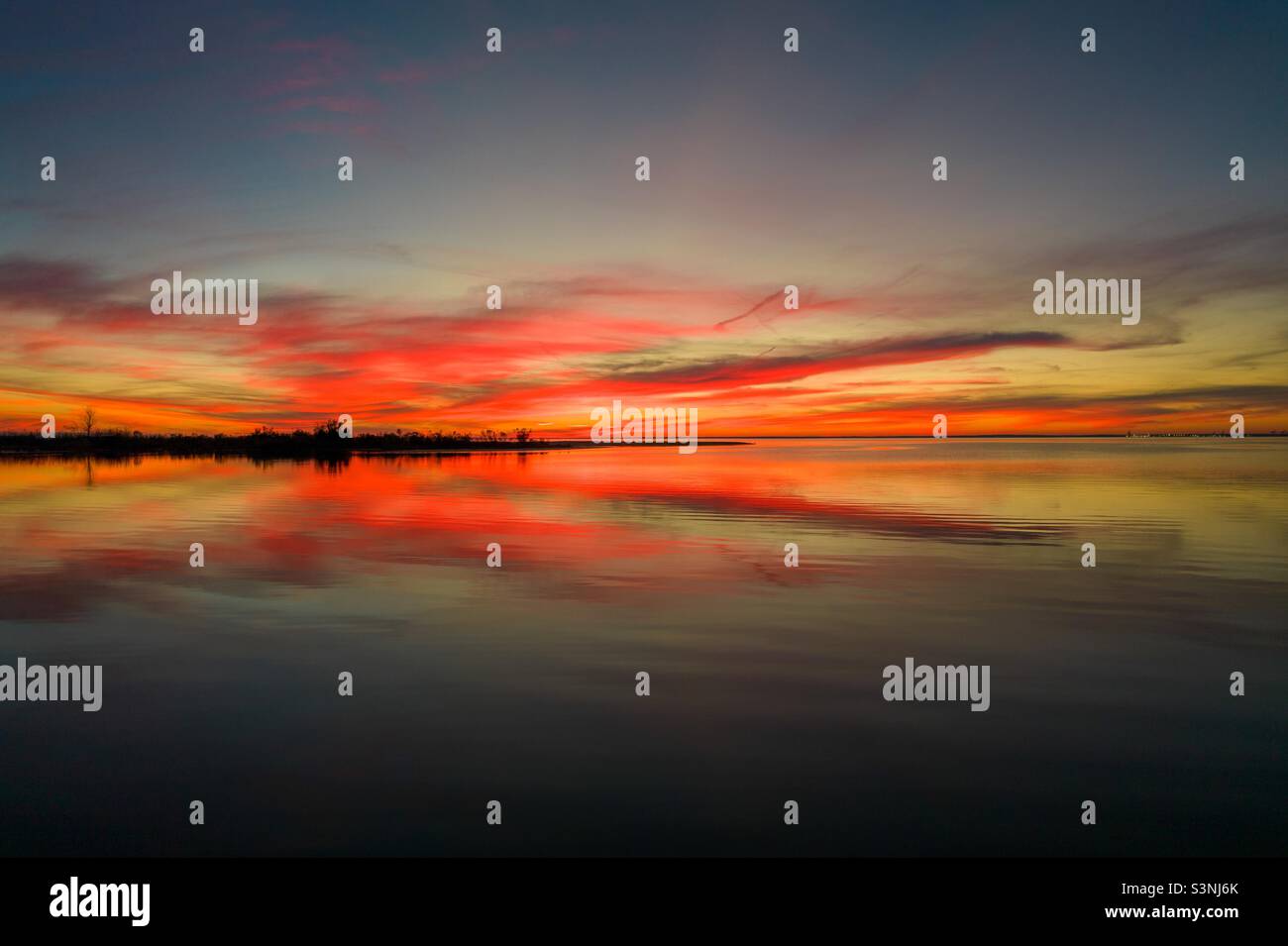 Sunset reflecting on the water Stock Photo - Alamy