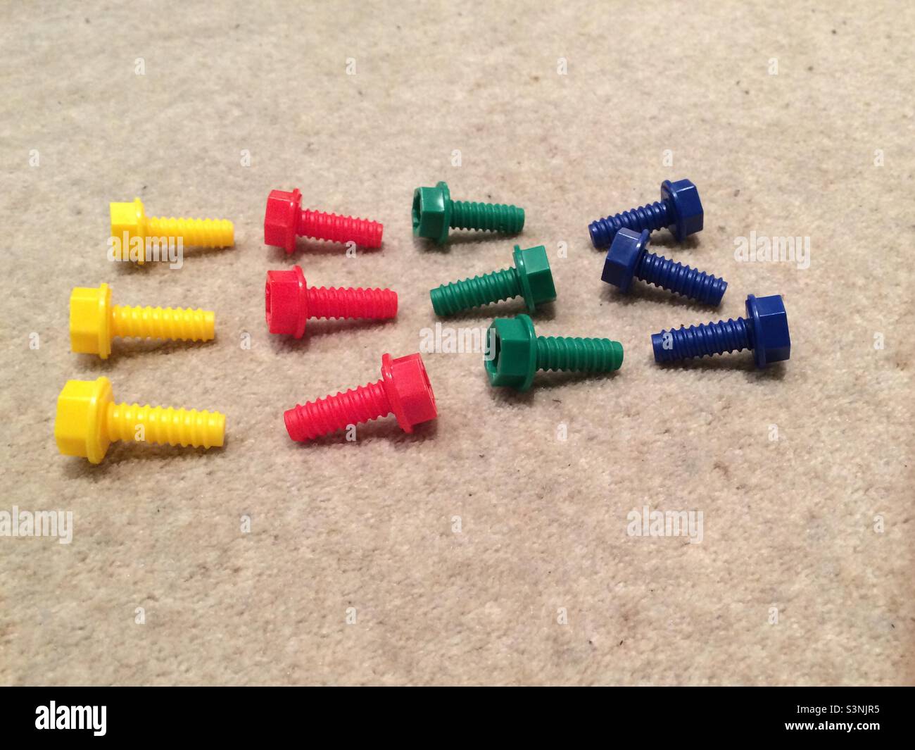 Coloured plastic toy bolts Stock Photo - Alamy