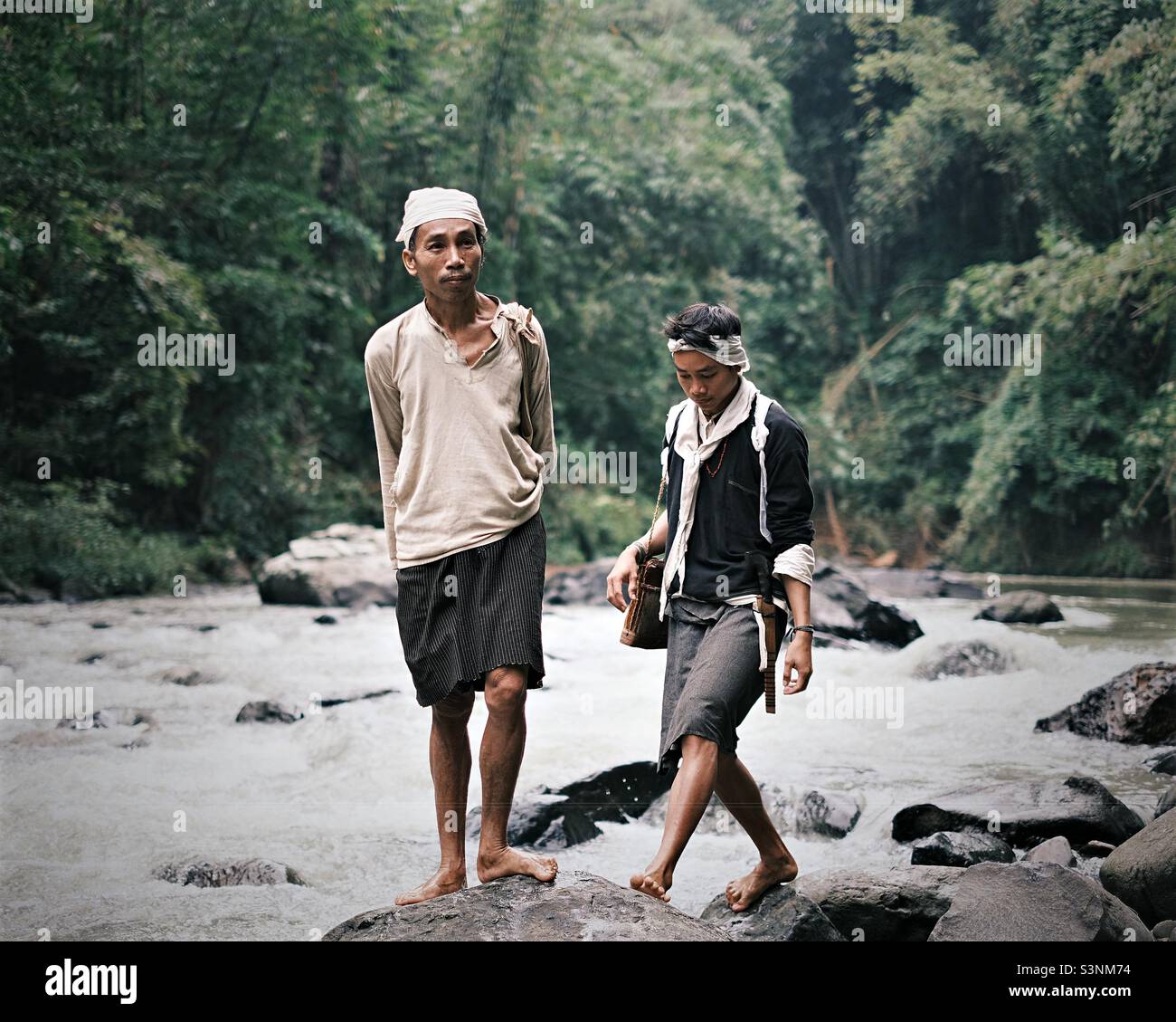 Two Inner Baduy tribe walked through the Ciujung river in the Kanekes ...