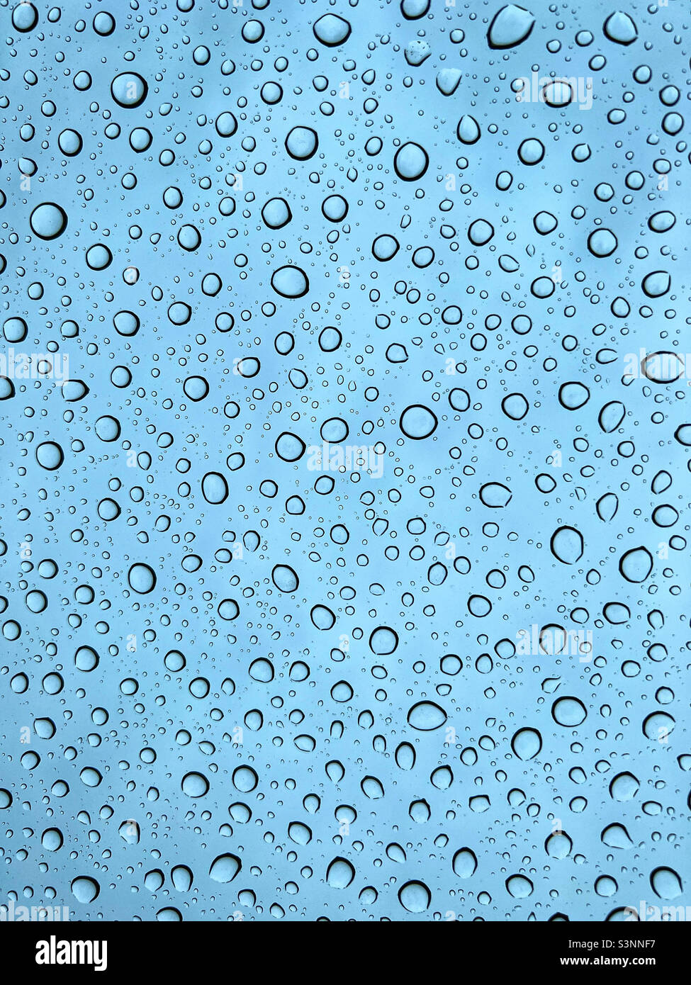 Droplet pattern against light blue background Stock Photo - Alamy