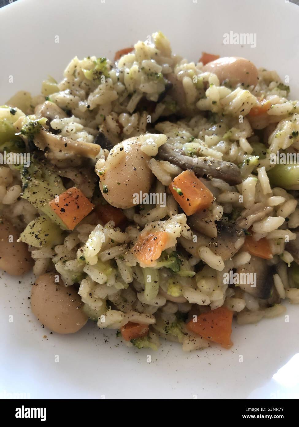 Vegan style risotto rice served with beans and vegetables Stock Photo ...