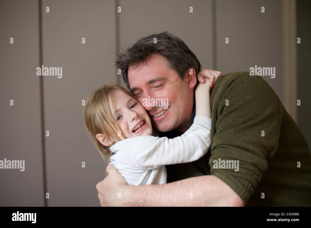 Dad hugging little girl hi-res stock photography and images - Alamy