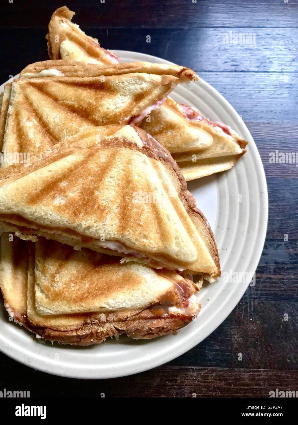 Plate of freshly cooked ham & cheese toasted sandwiches Stock Photo - Alamy