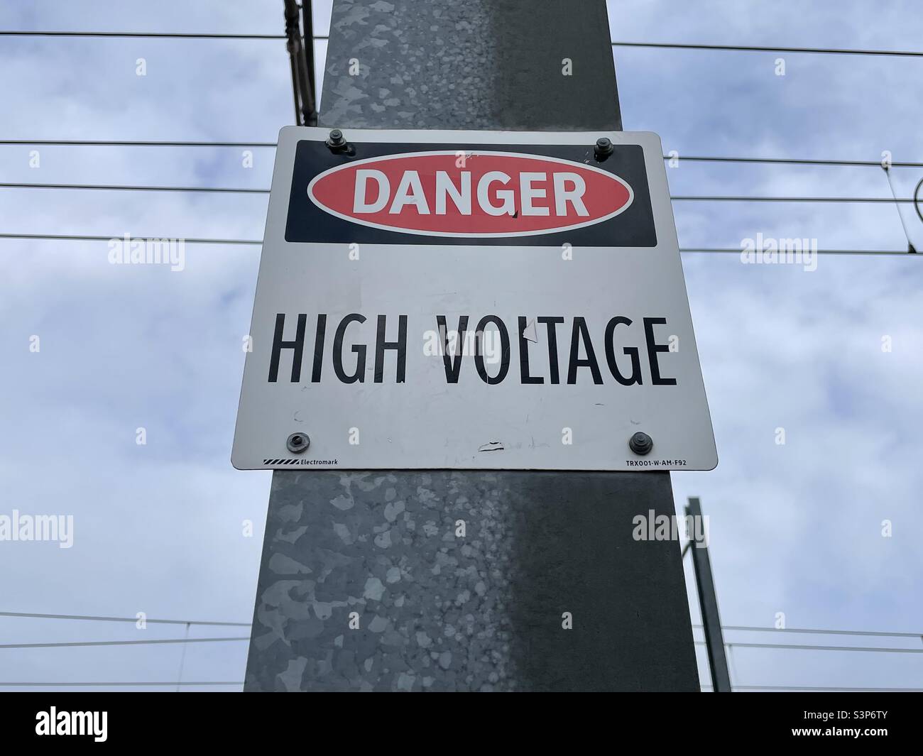 High voltage electricity sign with danger warning and wires in ...