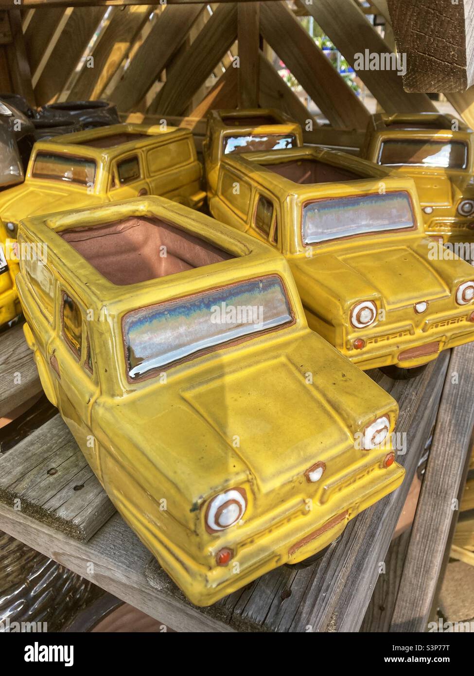 Yellow Car shaped plant pots at garden centre Stock Photo - Alamy
