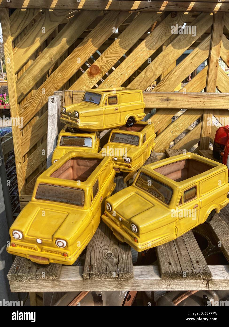 Yellow Car shaped plant pots at garden centre Stock Photo - Alamy
