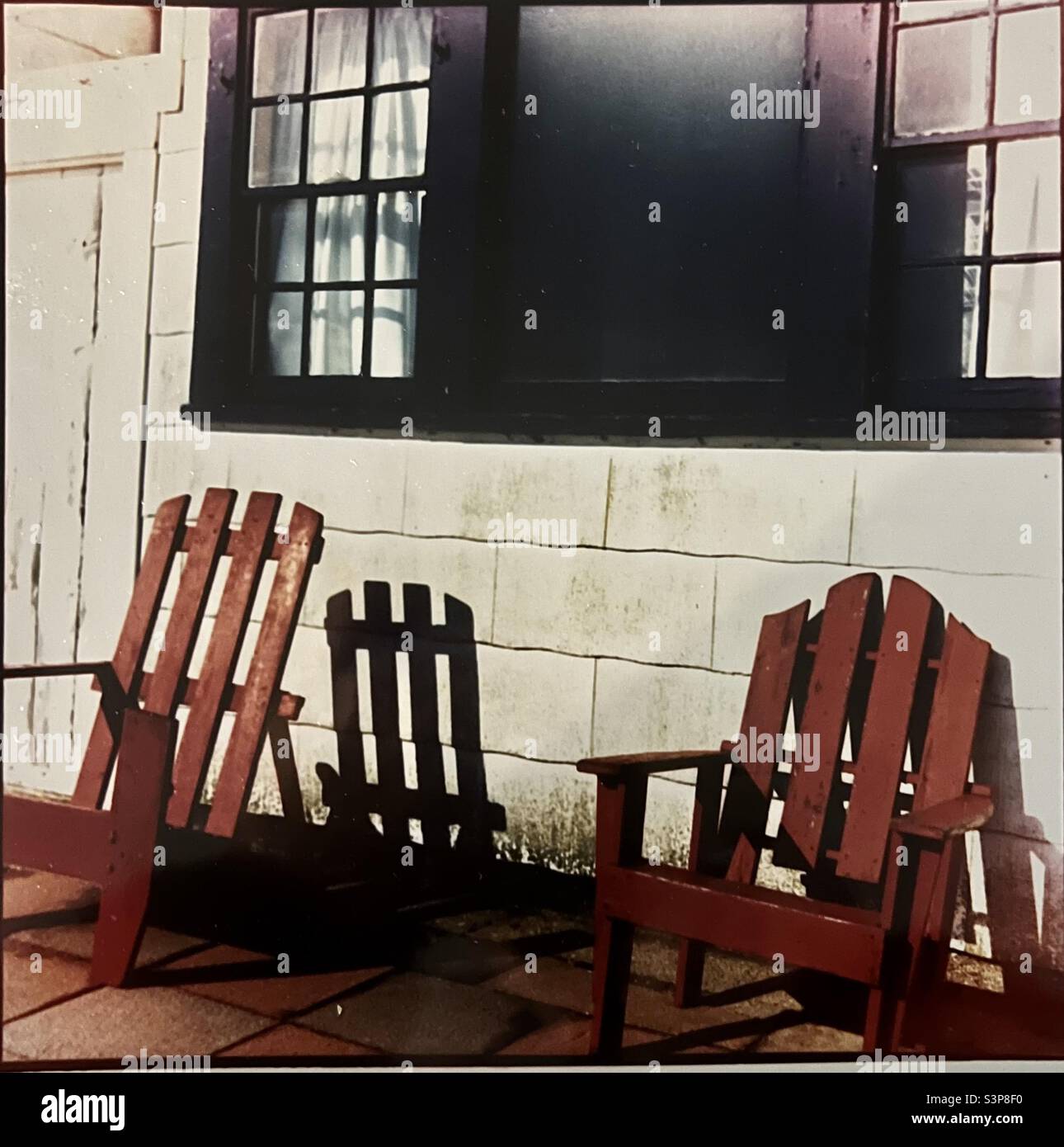 Red Adirondack chairs in front of Provincetown cottage Stock Photo - Alamy