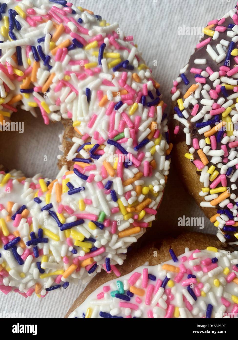 Colorful sprinkle donuts Stock Photo - Alamy