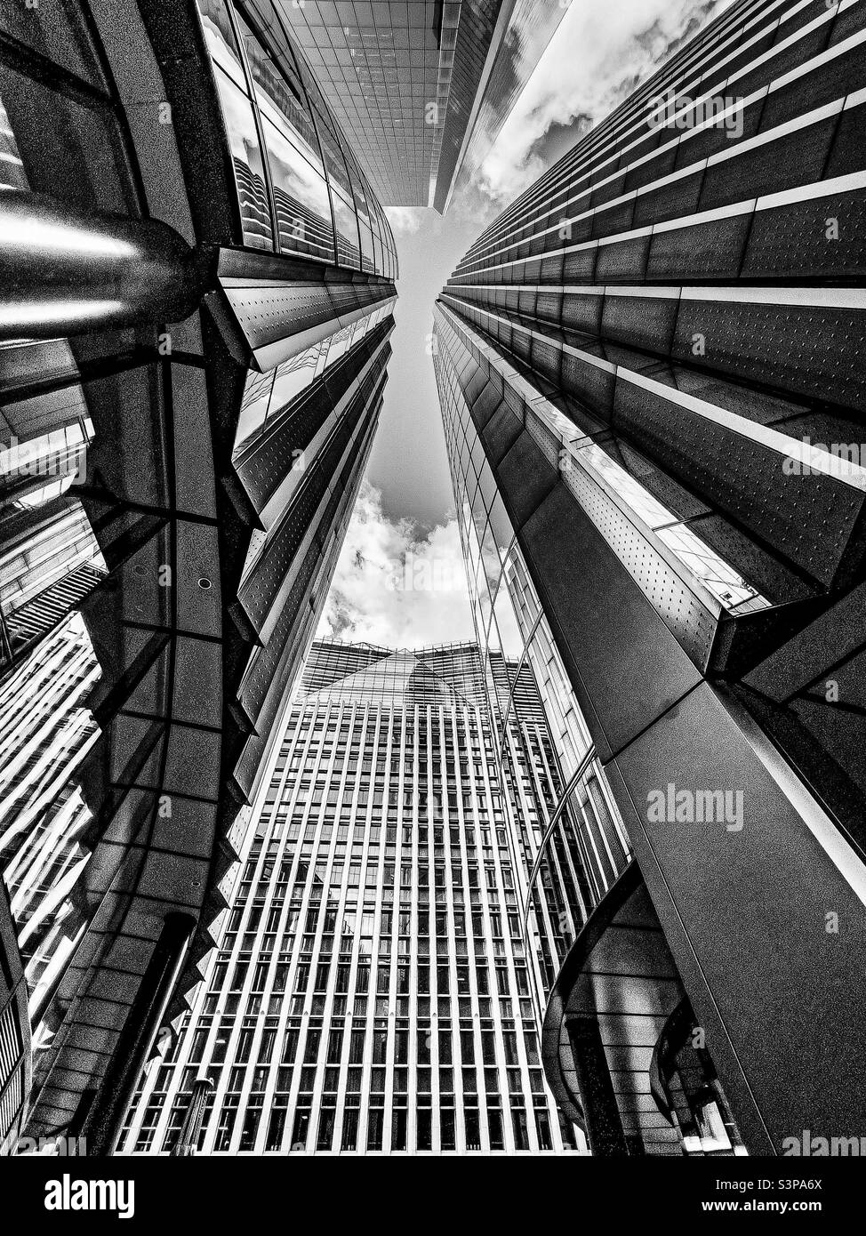 Dynamic view skywards in black and white from ground level of high rise ...