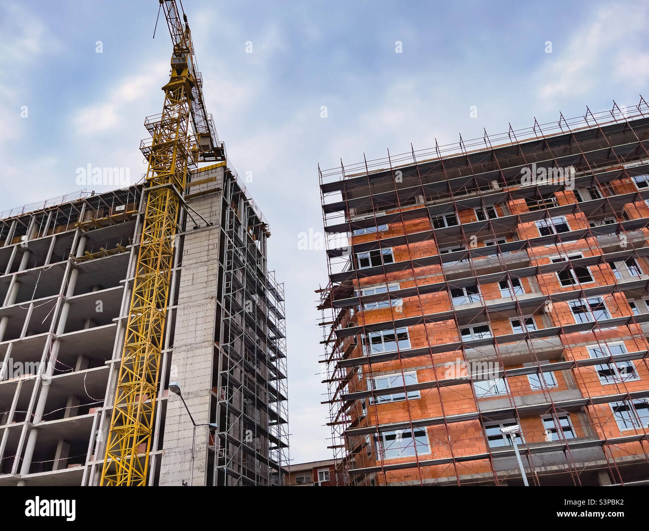 Building construction site with crane and scaffolding Stock Photo - Alamy