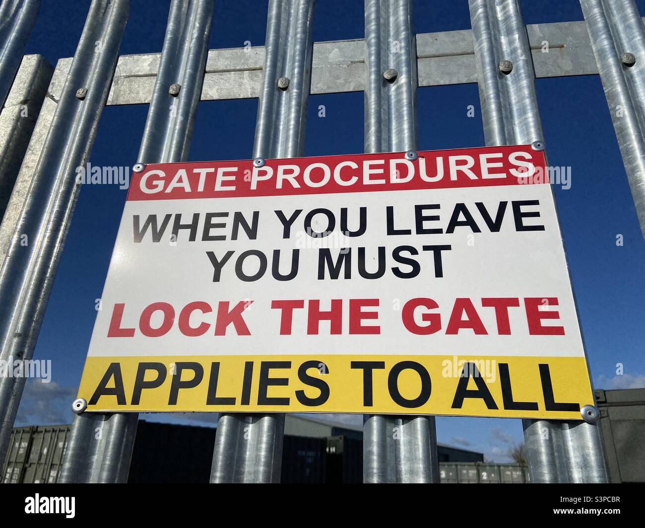 Lock the gate sign on an industrial site Stock Photo - Alamy