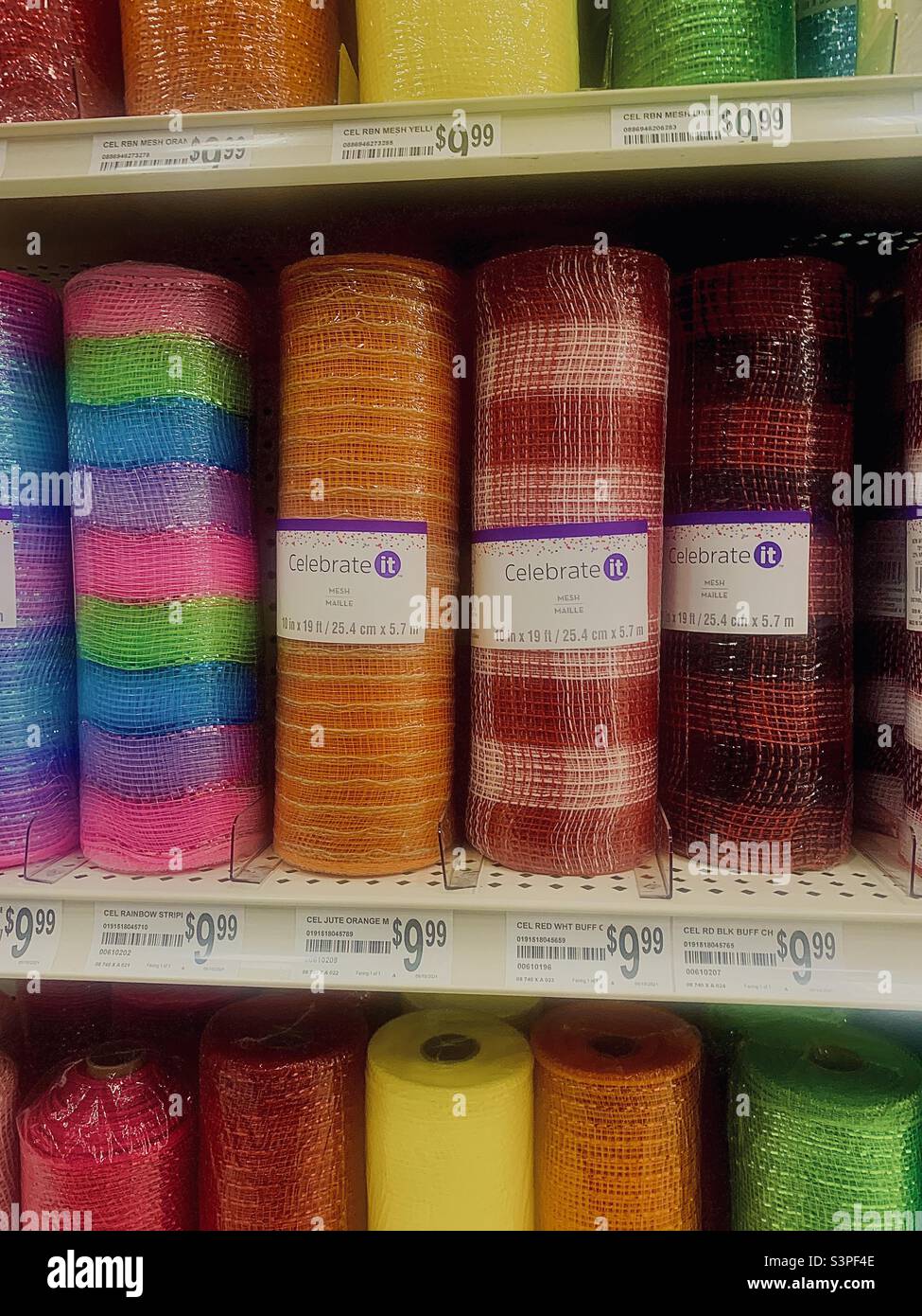 3 rows of colorful mesh fabric displayed on store shelf Stock Photo - Alamy