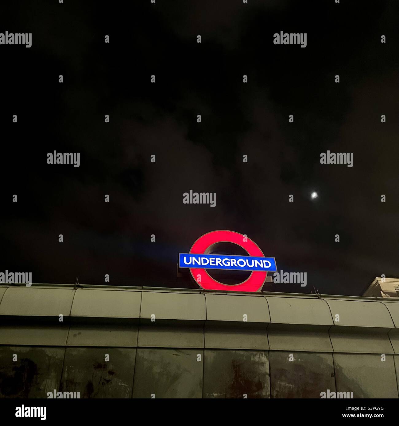 London Underground roundel sign in moonlight Stock Photo - Alamy