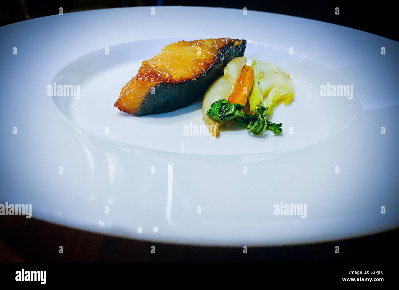 Gourmet serving of seared black cod (sablefish) with side of boo choy ...