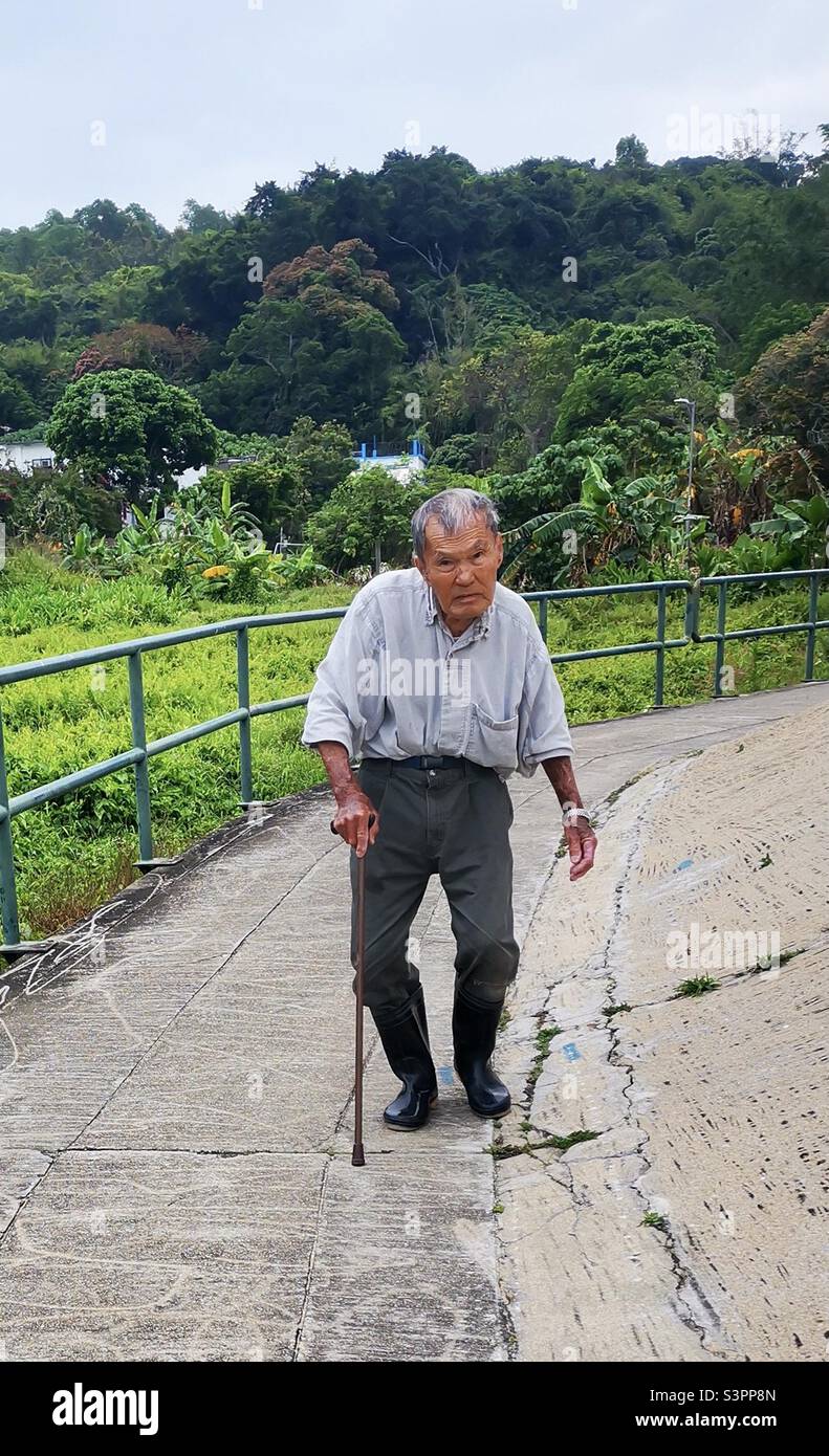 An elderly Chinese man walking in Lamma island in Hong Kong Stock Photo ...