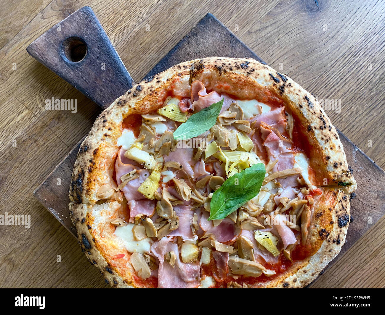Delicious pizza Capriciosa consisting of tomatoes, Mozzarella cheese ...