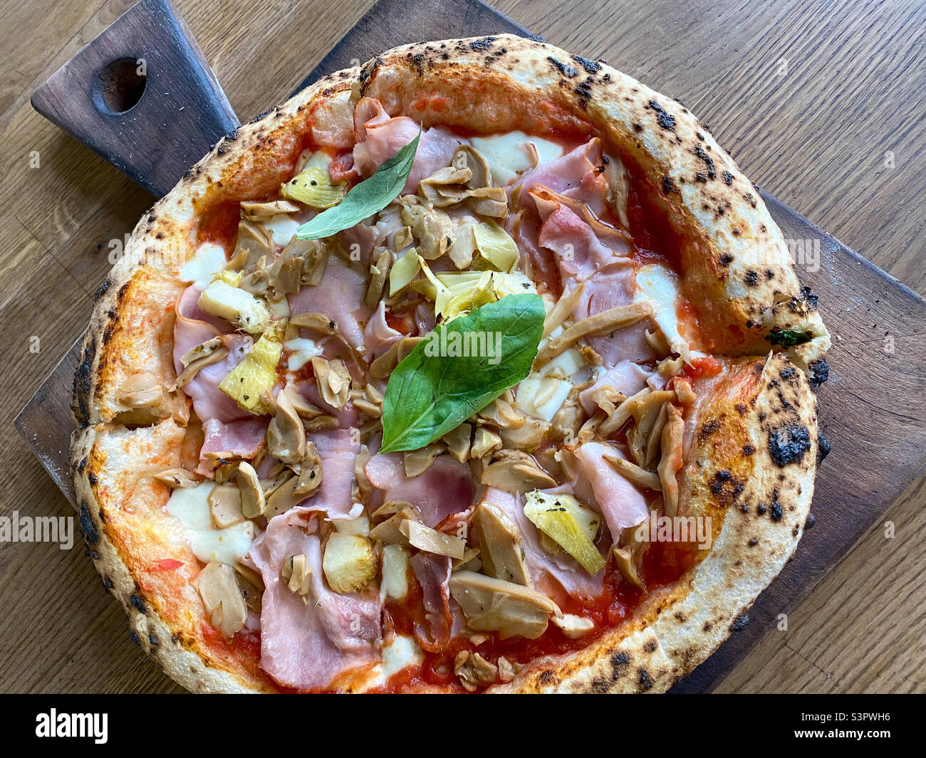 Delicious pizza Capriciosa consisting of tomatoes, Mozzarella cheese ...