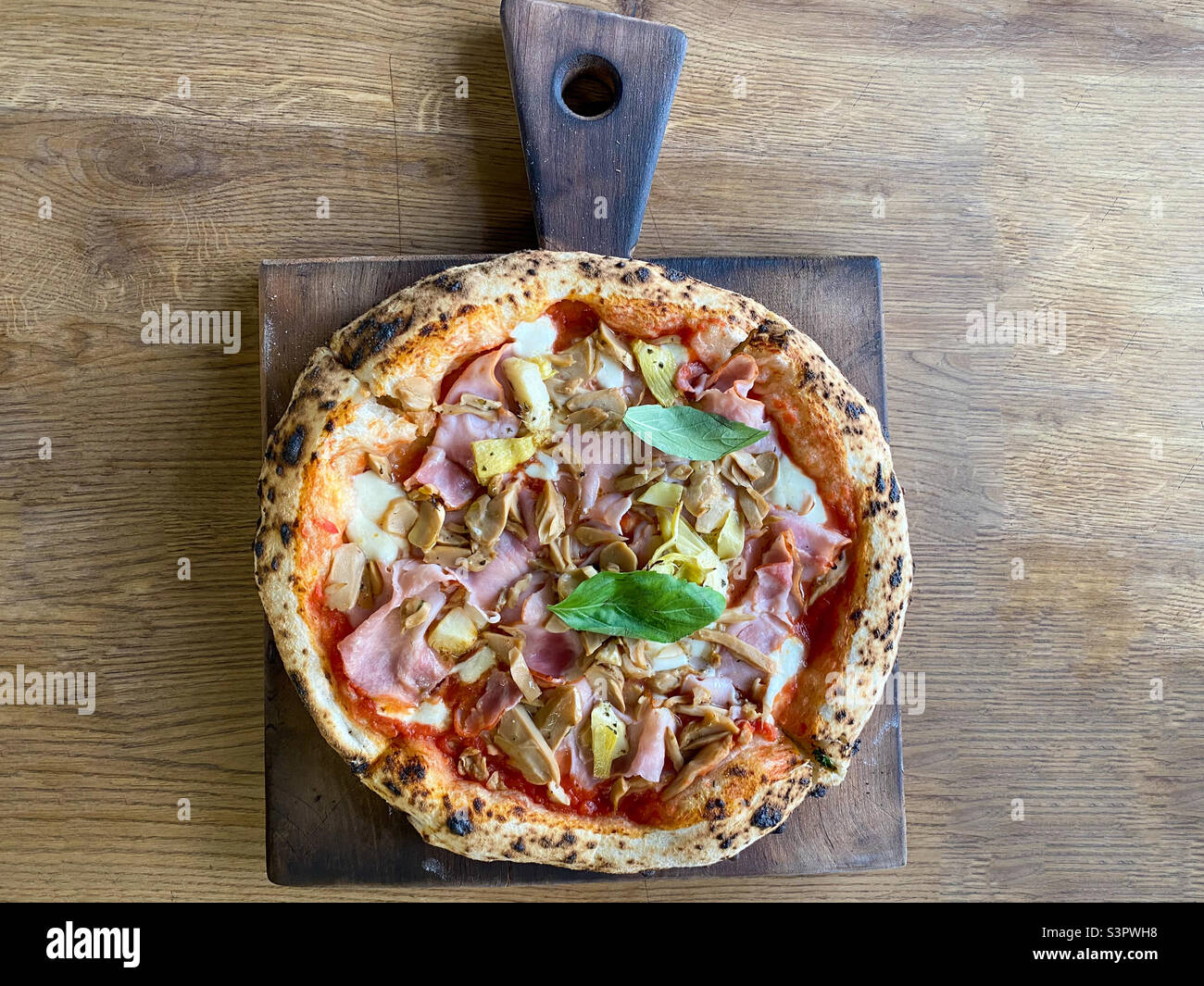 Delicious pizza Capriciosa consisting of tomatoes, Mozzarella cheese ...