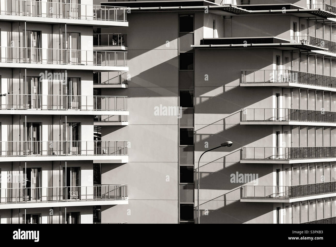 sunlight and shadows on a building with balconies Stock Photo - Alamy