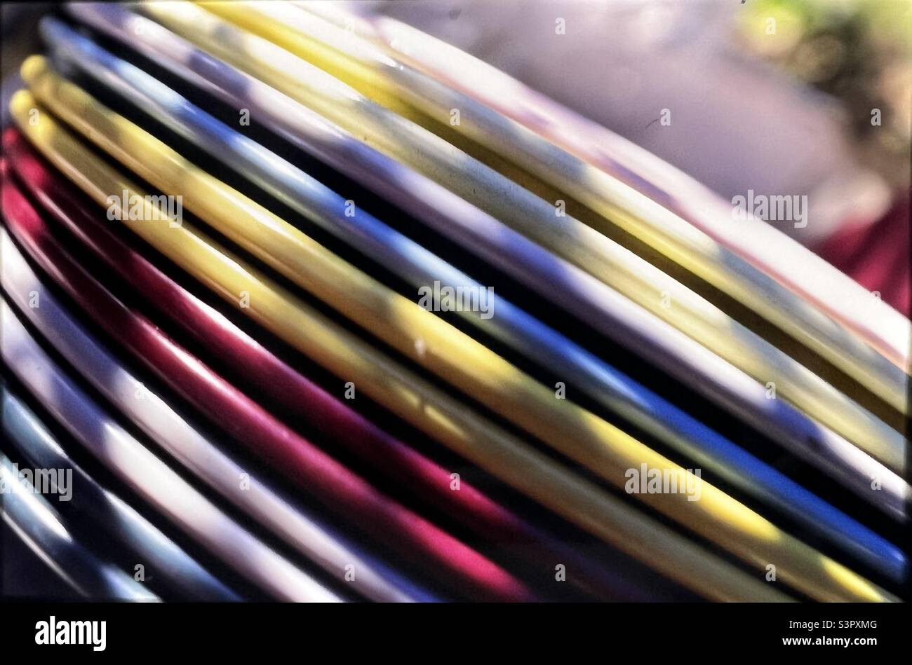 Colorful stack of dinnerware plates with range of different colors ...