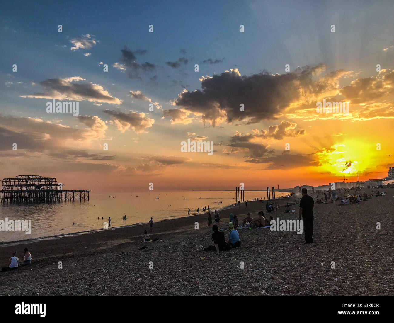 Brighton beach and pier at sunset Stock Photo - Alamy