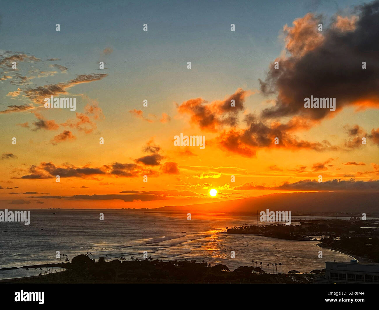 Hawaiian sunset as seen from Waikiki Beach, Honolulu, Oahu, Hawaii USA ...
