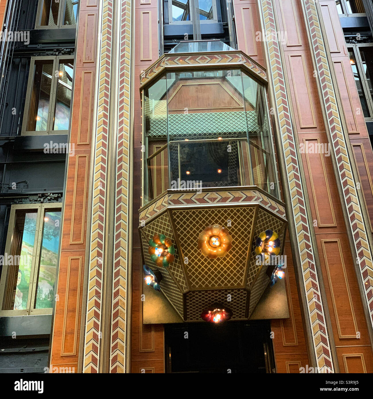 A glass elevator in the atrium of the Carnival Conquest cruise ship, in ...