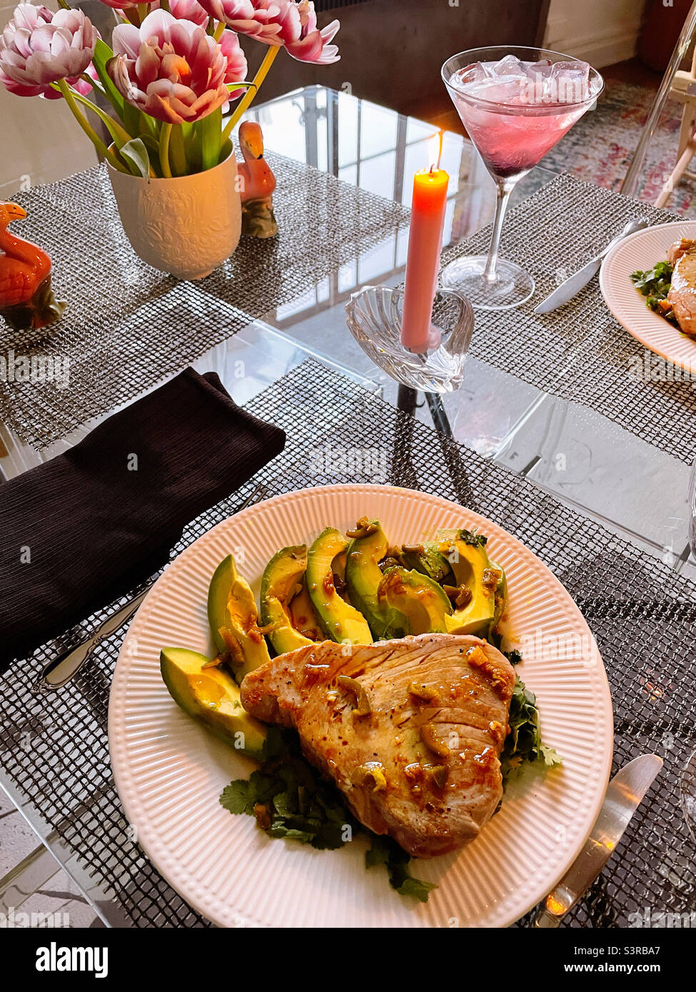 Upscale residential meal of seared salmon and avocado on a beautifully ...