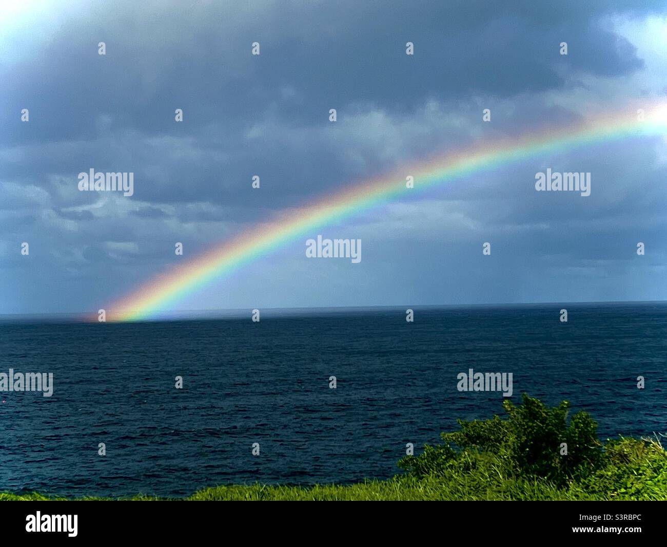 Rainbow over the Ocean Stock Photo - Alamy