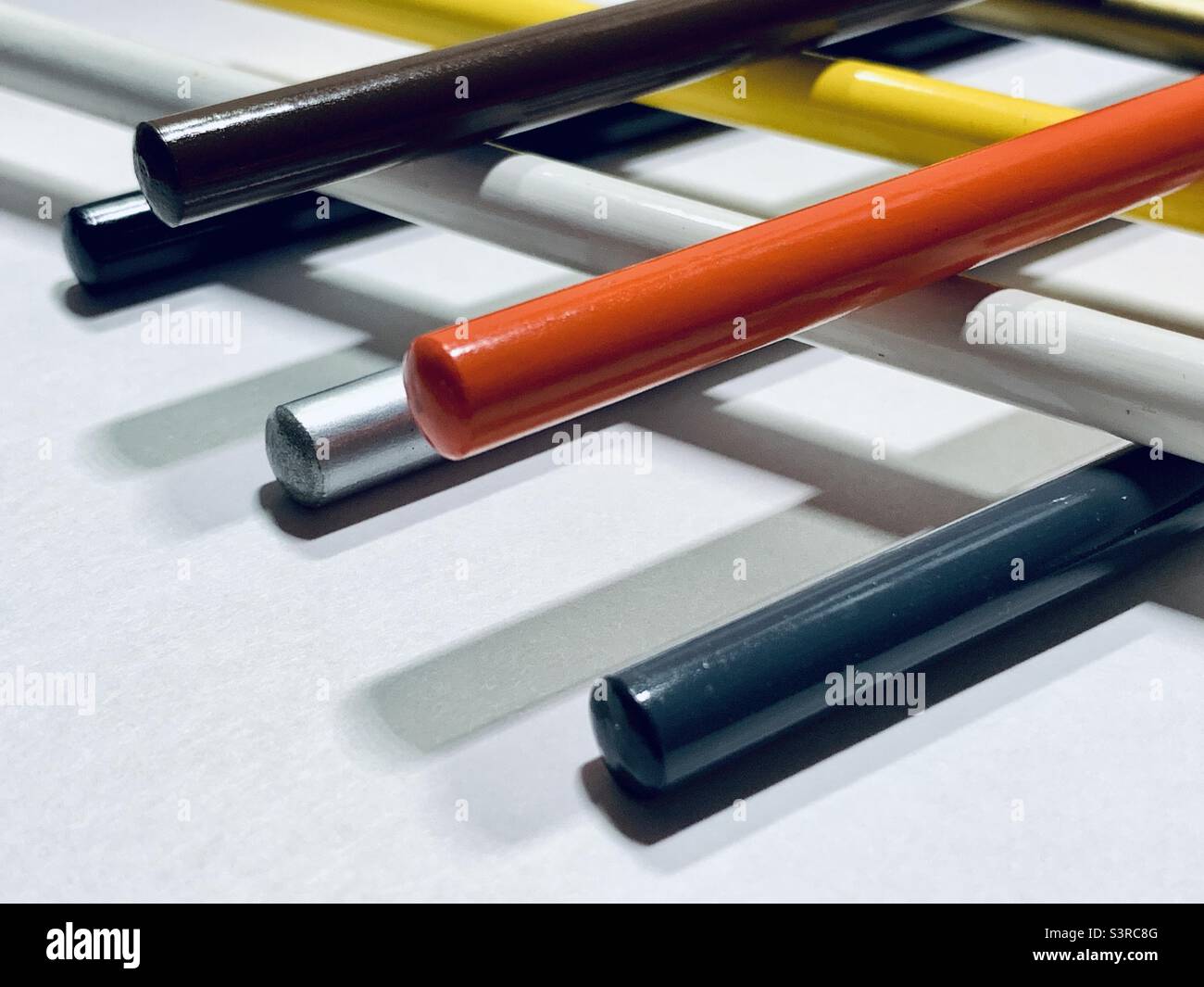 Colored pencils piled up on spacing Stock Photo - Alamy