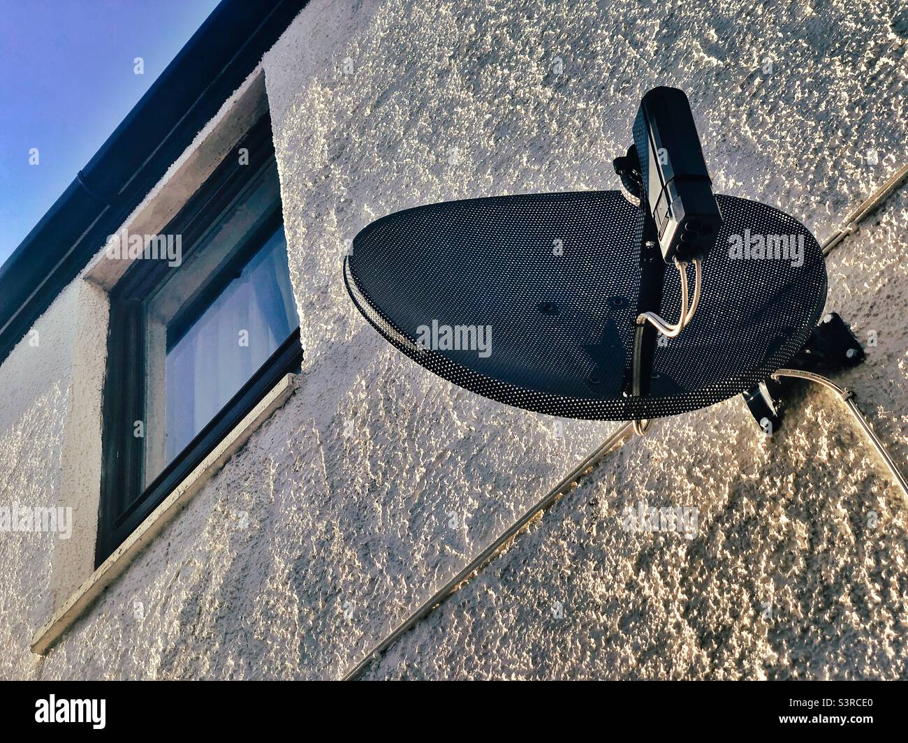 TV satellite dish outside a room window Stock Photo - Alamy