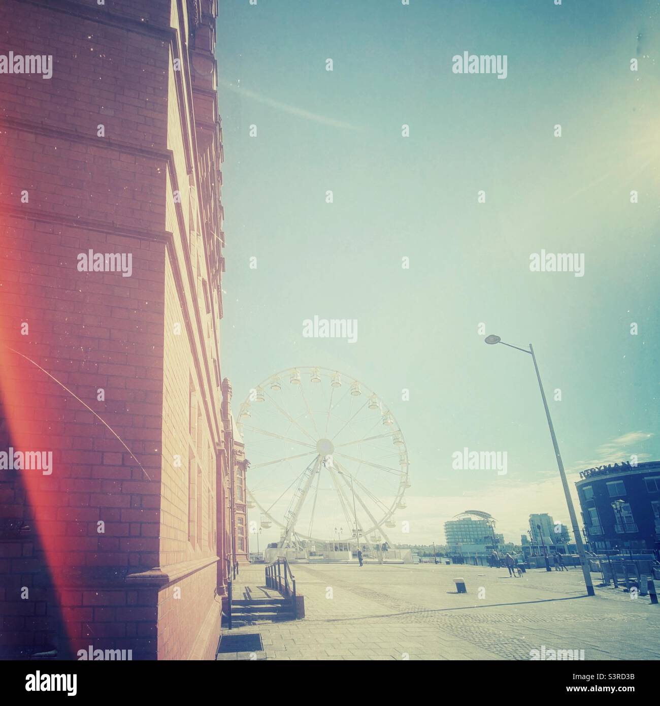 A photograph of the big Ferris Wheel in Cardiff Bay, next to the red ...