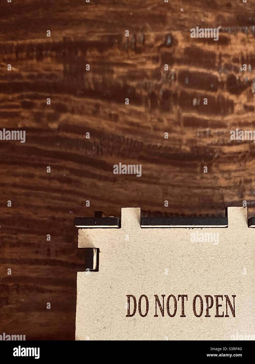 DO NOT OPEN puzzle box in bottom corner on brown table with negative ...