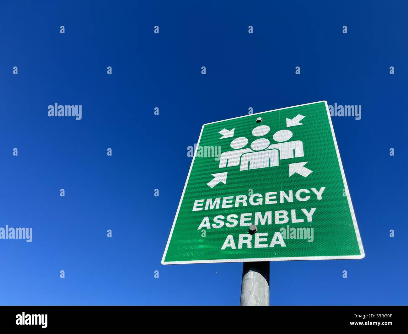 Emergency assembly area sign against blue sky Stock Photo - Alamy