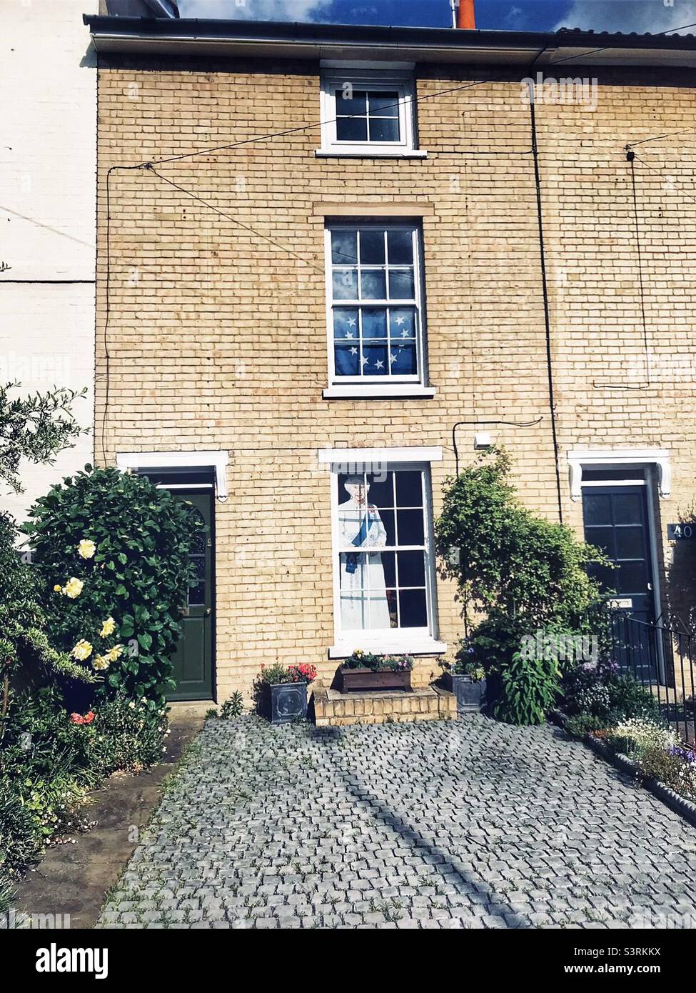 English home with a window display of Her Majesty The Queen and the ...