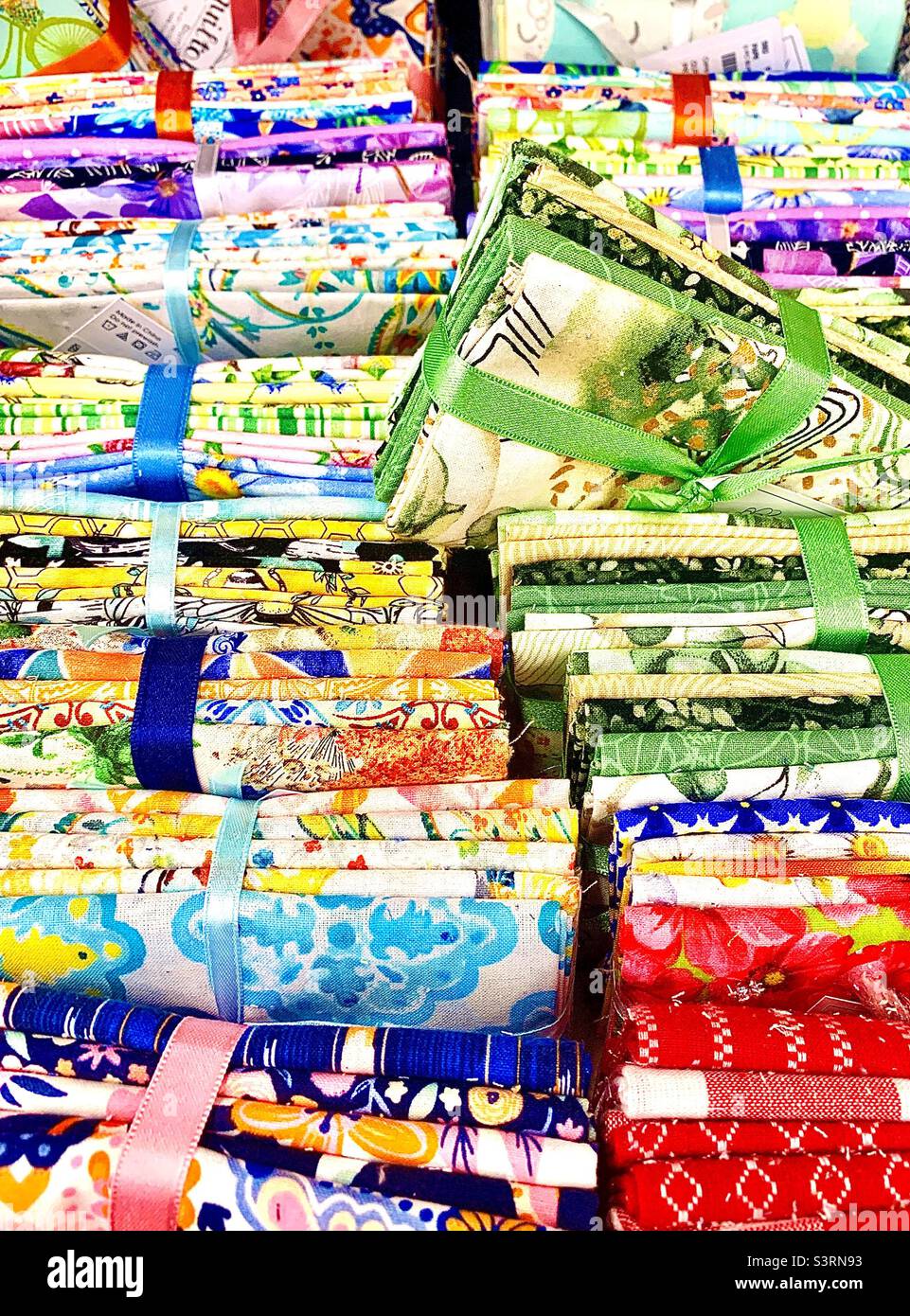 Large selection of colorful fabric swathes in two rows Stock Photo - Alamy