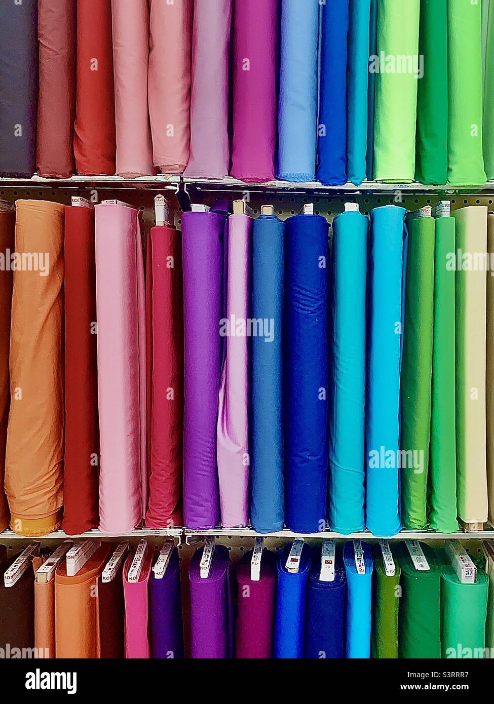 Three vertical rows of colorful, vibrant, fabric samples Stock Photo ...