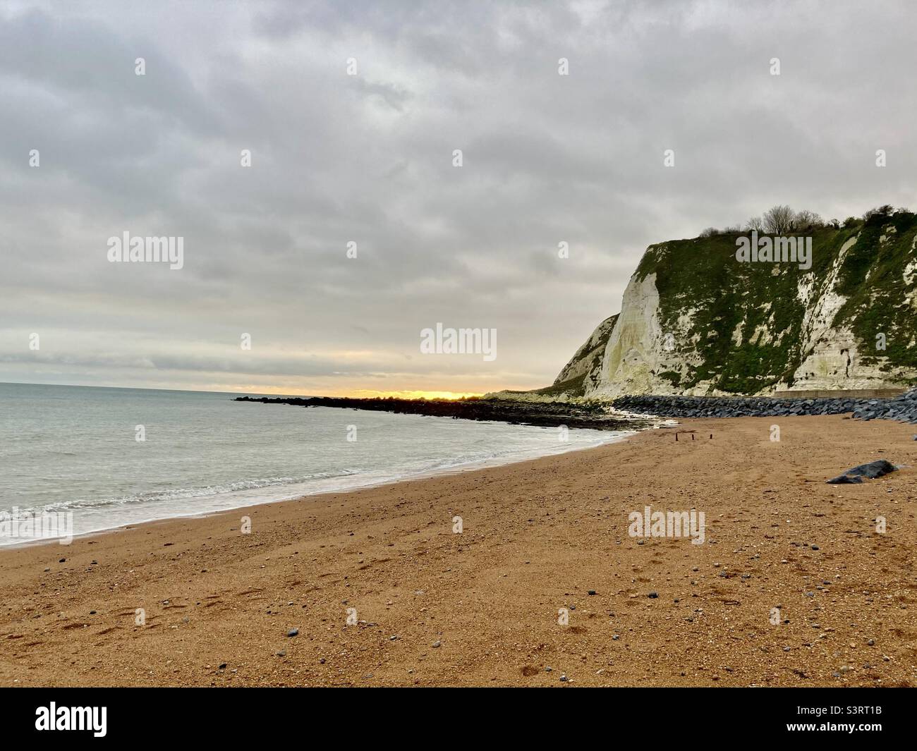 Shakespeare beach , with Shakespeare cliff and the sun setting Stock ...