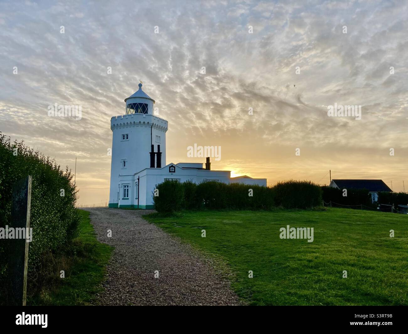 Sun setting behind south foreland lighthouse Stock Photo - Alamy