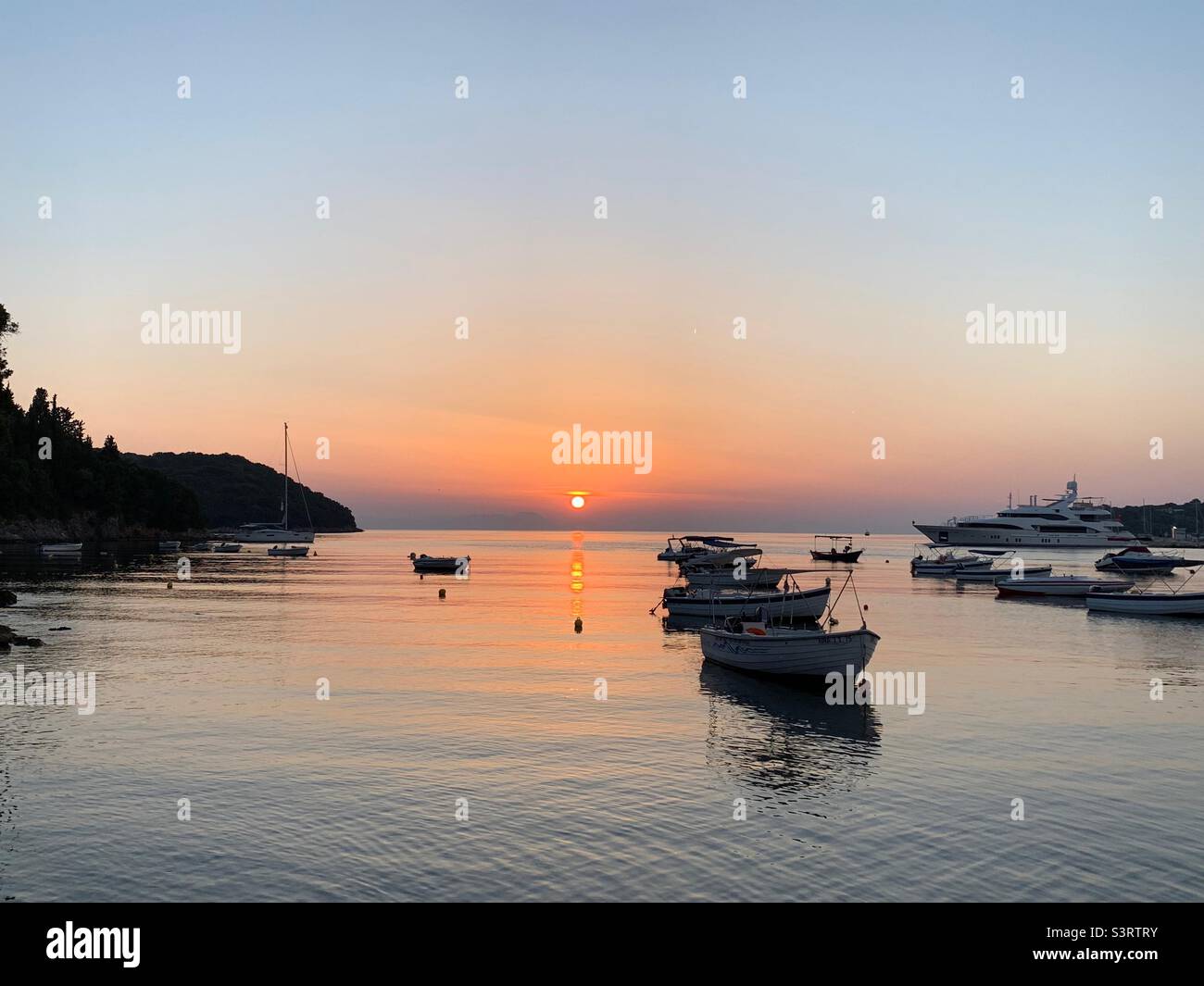 Greek harbour sunset Stock Photo - Alamy