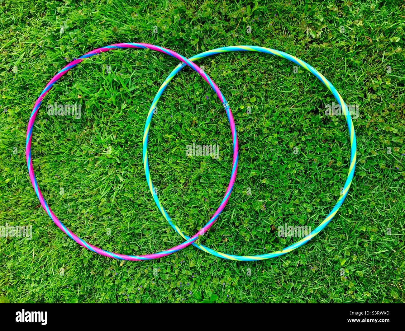 Two overlapping hula-hoops on grass. A Colorful, stylized VENN figure ...